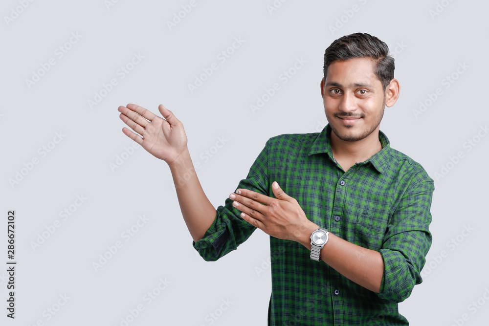 young indian college student showing direction Stock Photo | Adobe Stock