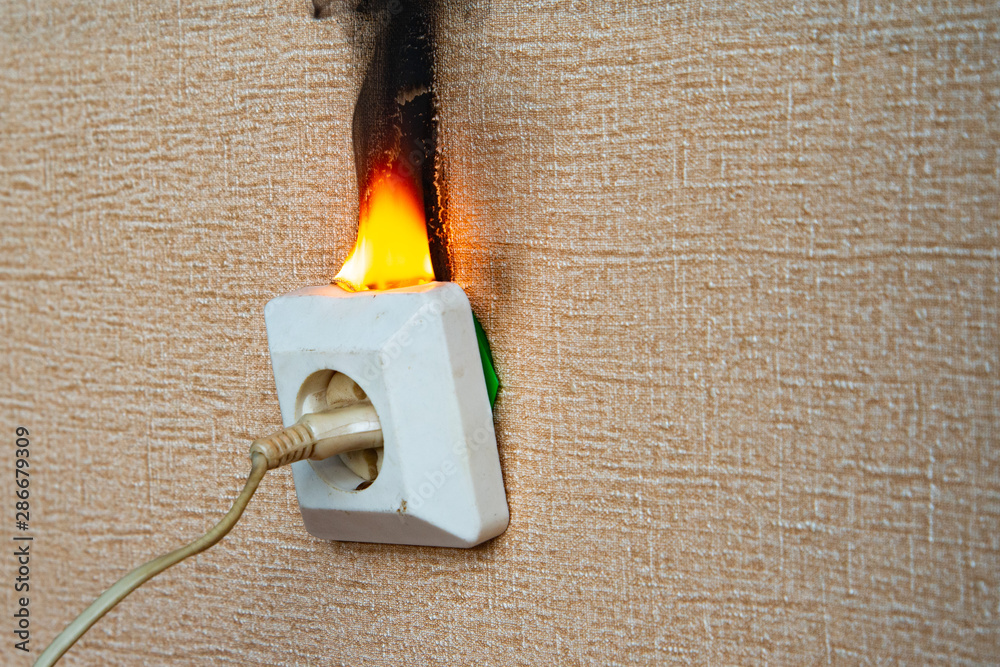 Burning electrical wiring and electrical outlet. Faulty wiring causes ...