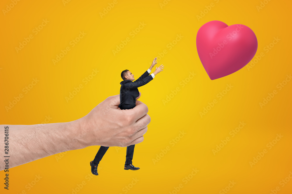 Big hand holding small businessman reaching out with his both hands for ...