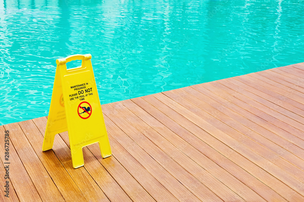 warning sign at the edge of swimming pool Stock Photo | Adobe Stock