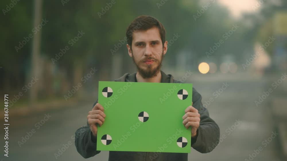 Demonstrator with beard closeup look at camera background empty city ...