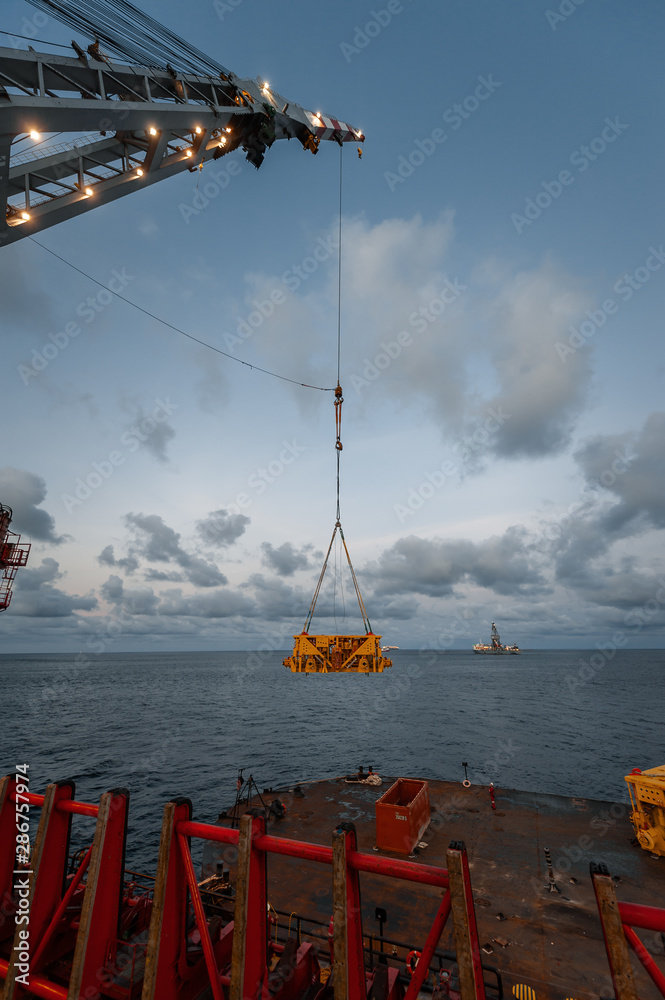 Crane lifter lifting heavy load Stock Photo | Adobe Stock