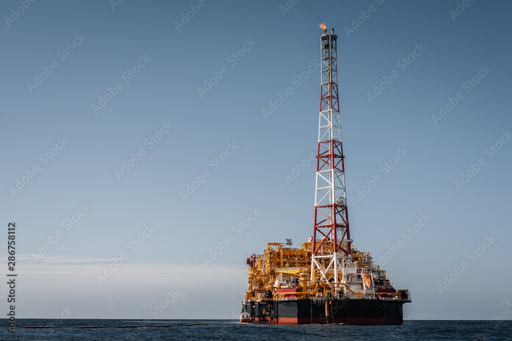 Long view of flare boom nozzle and fire on offshore oil rig Stock Photo ...