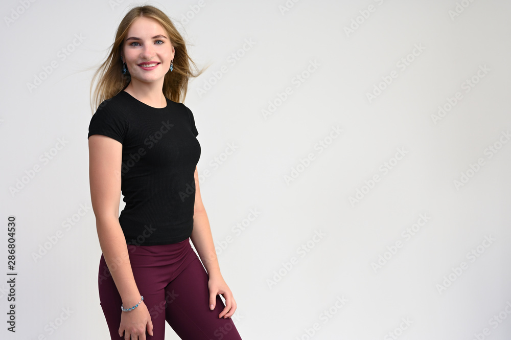 A knee-length portrait of a pretty brunette girl with long flowing hair ...