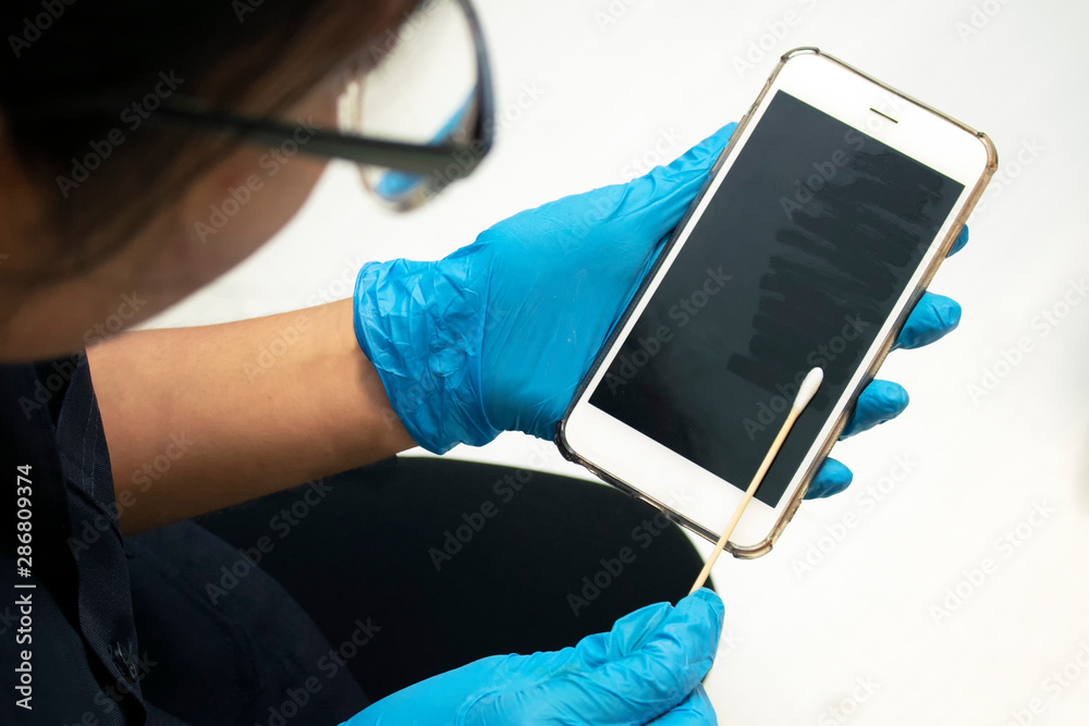 Hand holding cotton swab stick and swab dipped in diluted rubbing ...
