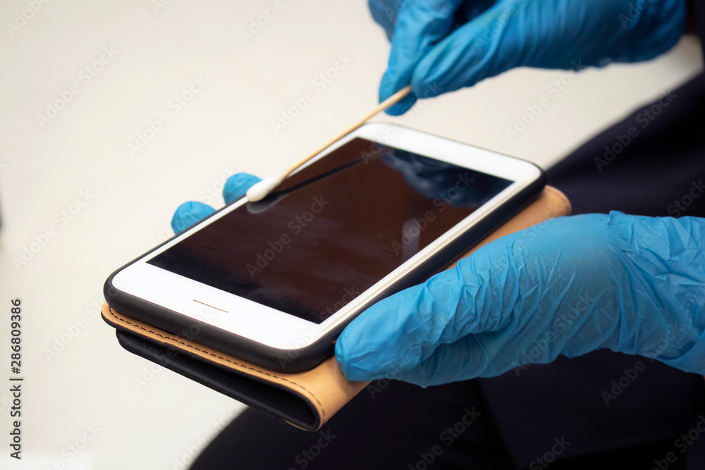 Hand holding cotton swab stick and swab dipped in diluted rubbing ...