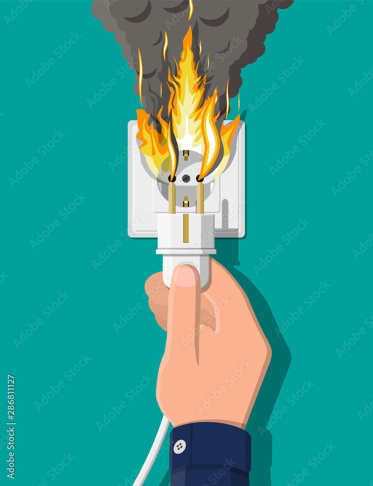 Electrical outlet with plug on fire. Overload of network. Short circuit ...