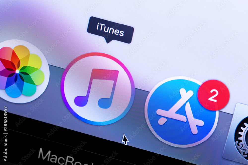 Apple Macbook with iTunes and App Store icons app on the screen. App ...