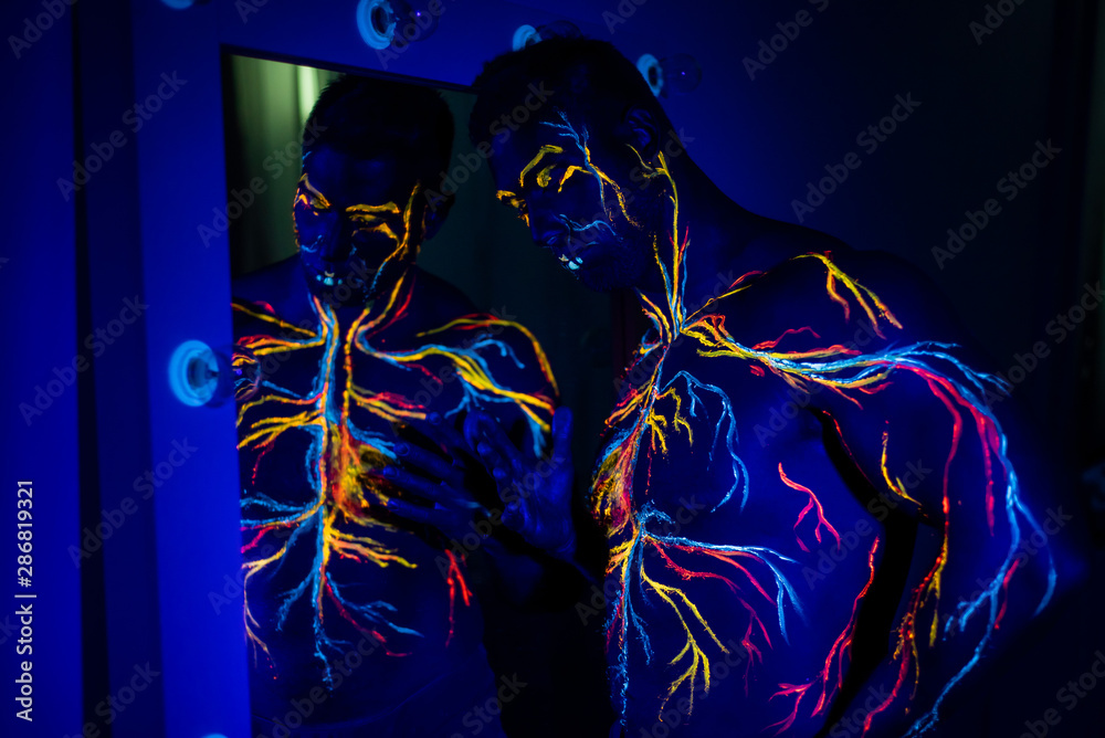 UV patterns body art of the circulatory system on a man's body. On the ...