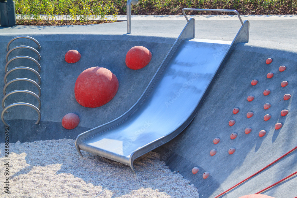 modern Playground with a metal slide inscribed in a contemporary ...
