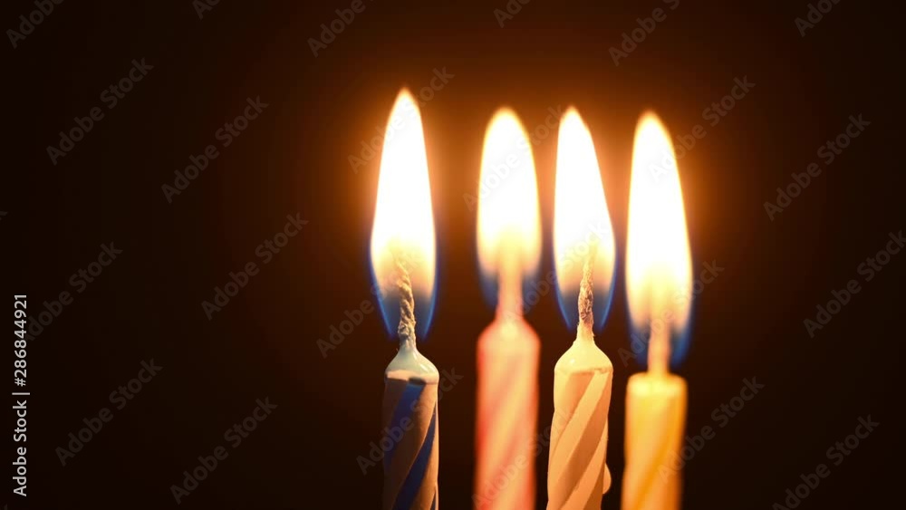 Four burning candles that are consumed over time. Birthday time. 4K ...