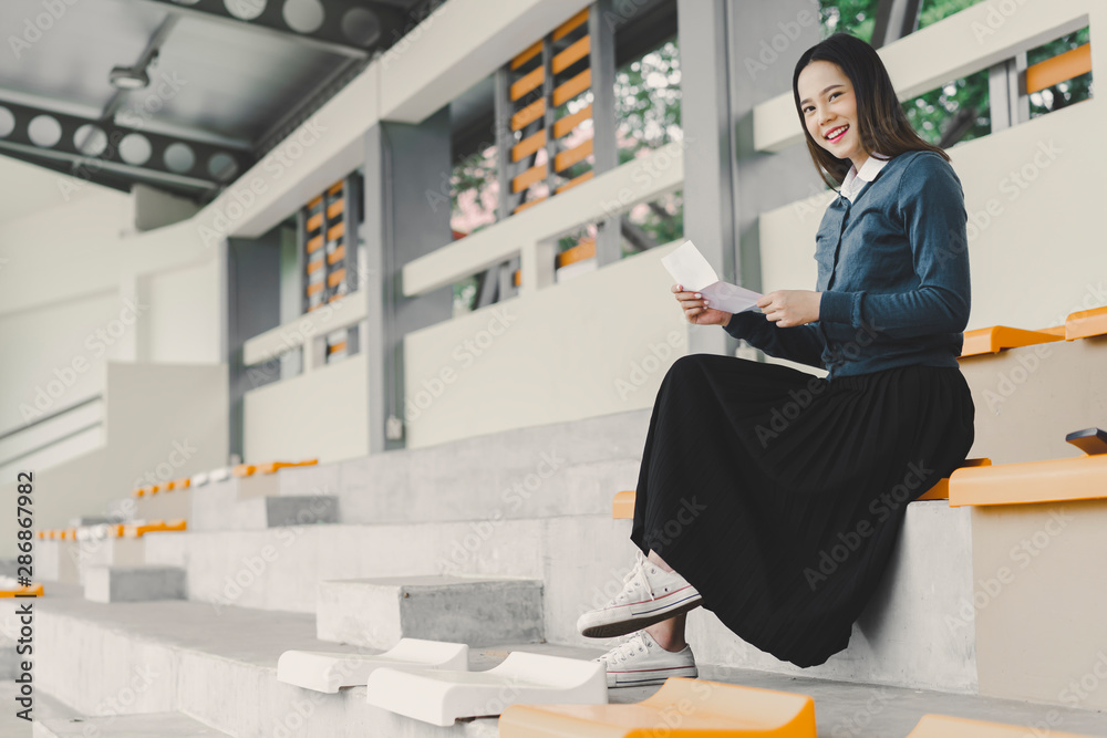 Asian female student holding papers or Graduation certificate hands and ...