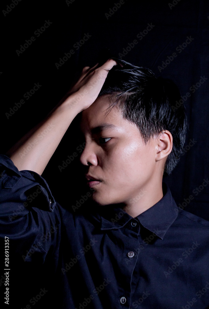 Asian men aged 21-29 years old Making sad faces and using hands to hold ...