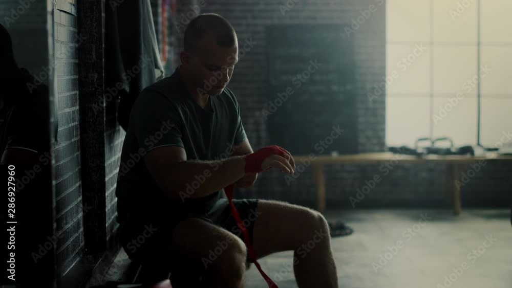 Strong and Handsome Male Wrapping His Hands with Handwraps to Start His ...