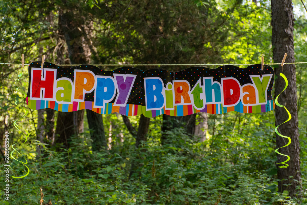 Happy Birthday sign panorama in the outdoor trees with balloons and ...