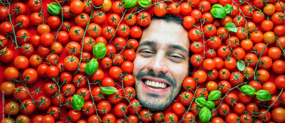 Man with tomatoes , concept for the food industry. Face of laughing men ...