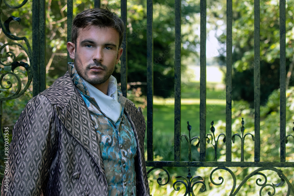 Portrait of handsome gentleman dressed in vintage costume standing in ...