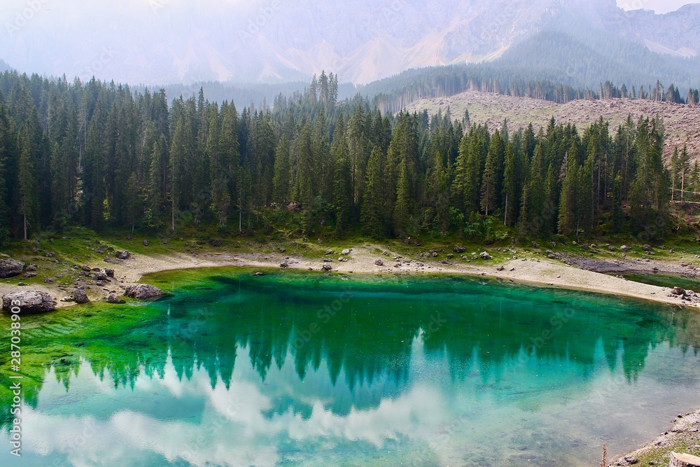 Lake Carezza, the small mountain lake is famous for the dark green ...
