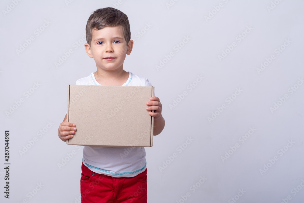 New purchases or delivery from shop. Happy boy smiling hold the box ...