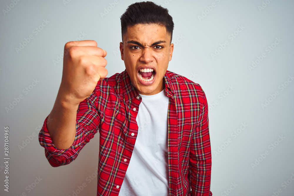 Young brazilian man wearing red shirt standing over isolated white ...