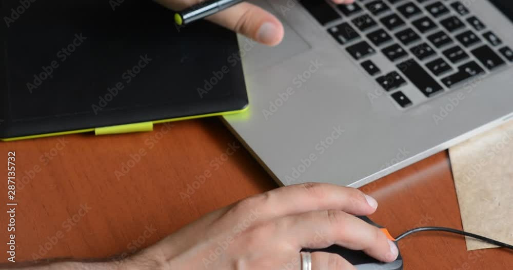 Close-up of the hands of an ambidexter designer who works equally well ...