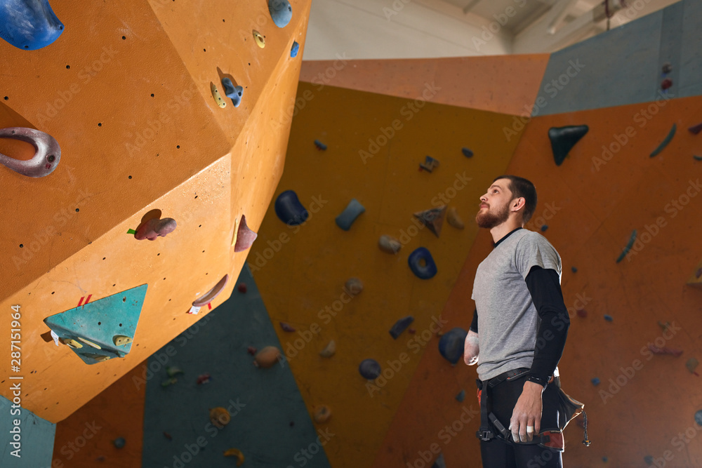 Side view of athletic rock-climber without forehand prepairing to hard ...