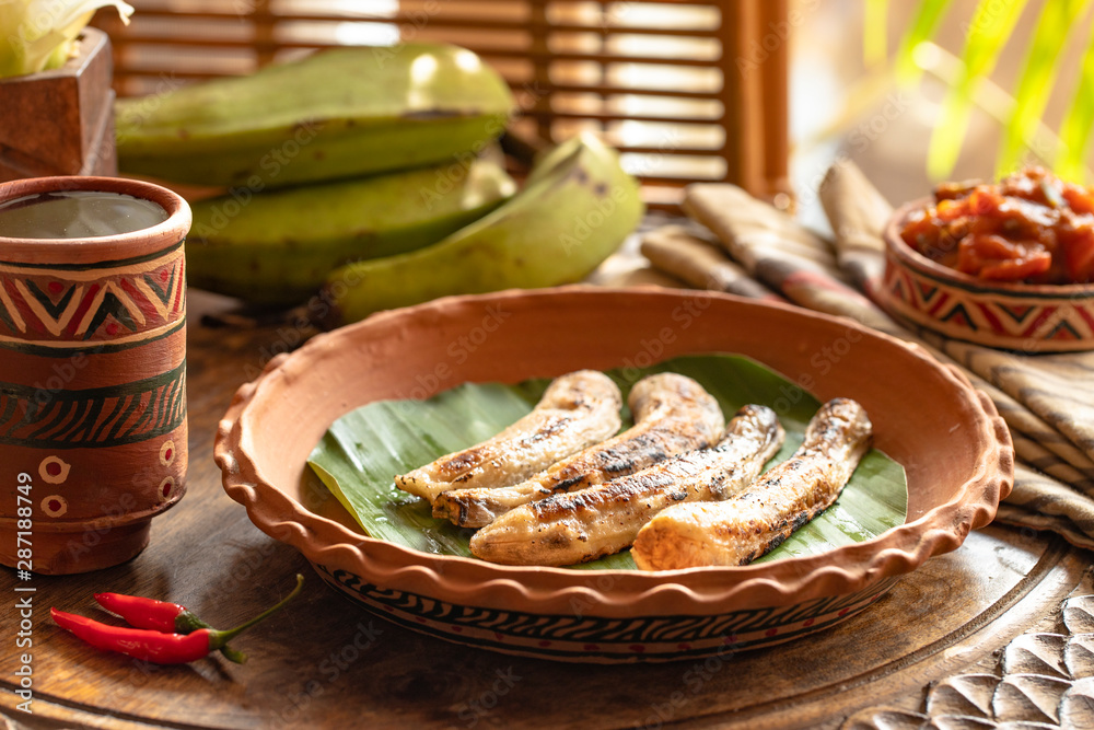 african food. African cuisine called Boli and sauce. fried bananas ...