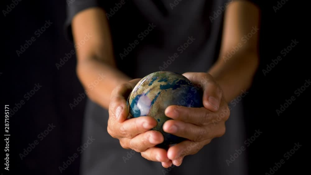 Female hand holding a realistic Earth. Holding the world in your hand ...