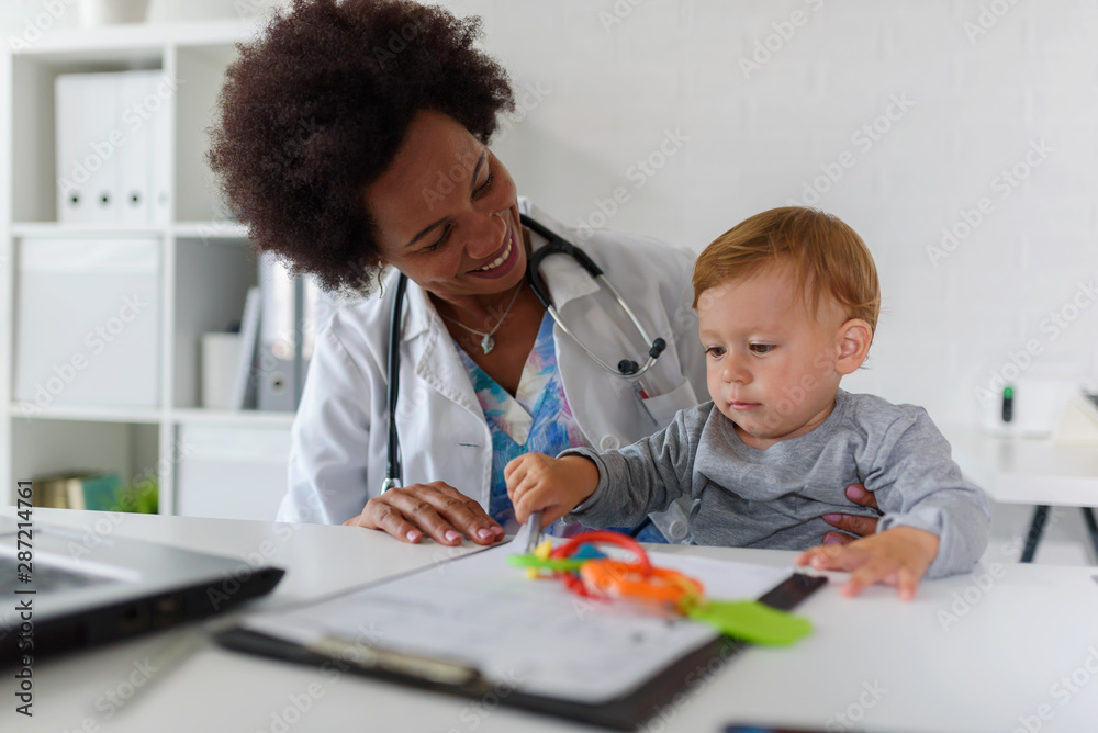 Smiling female doctor pediatrician with baby patient Stock Photo ...