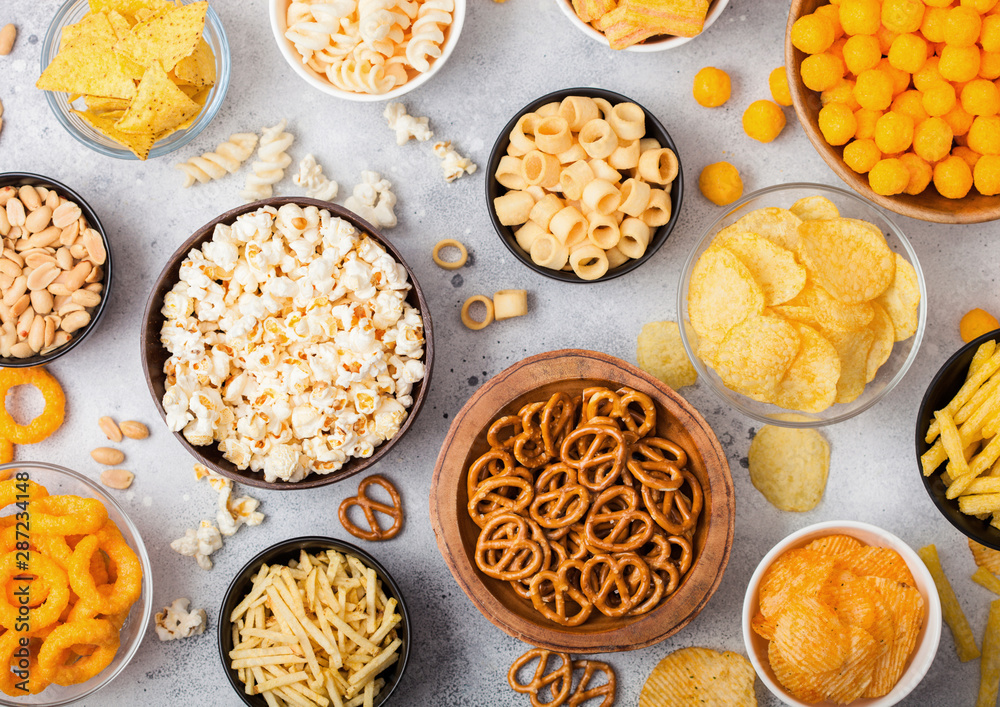 All classic potato snacks with peanuts, popcorn and onion rings and ...