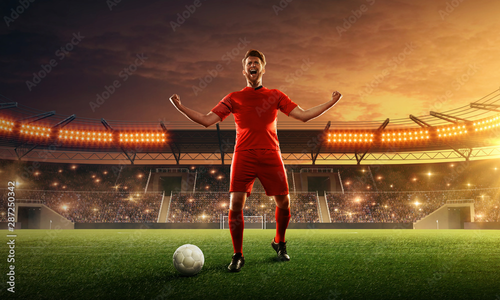 Soccer player celebrates victory on a stadium in front of cheering fans ...