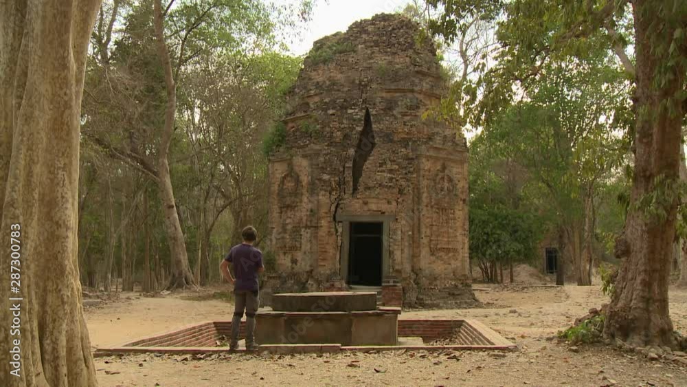 A steady wide shot of the stone bricks temple of Khmer ruins of Sambor ...
