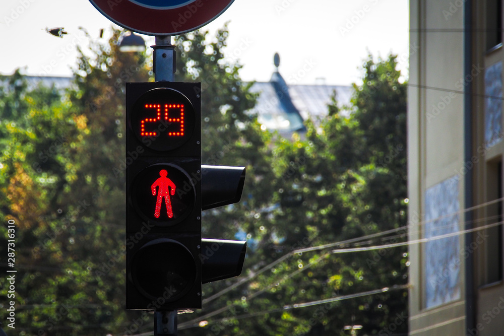 The red light of traffic light on the pedestrian crossing of a human ...