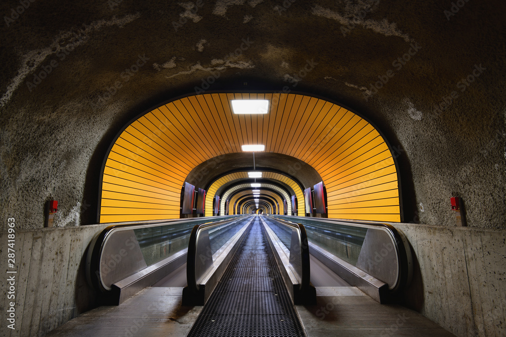 Pedestrian subway, illuminated tunnel, with two moving walkways. Stock ...