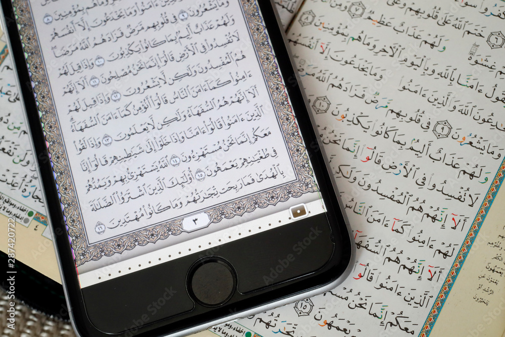 Digital Quran on a smartphone and Holy Quran book, Vietnam Stock Photo ...