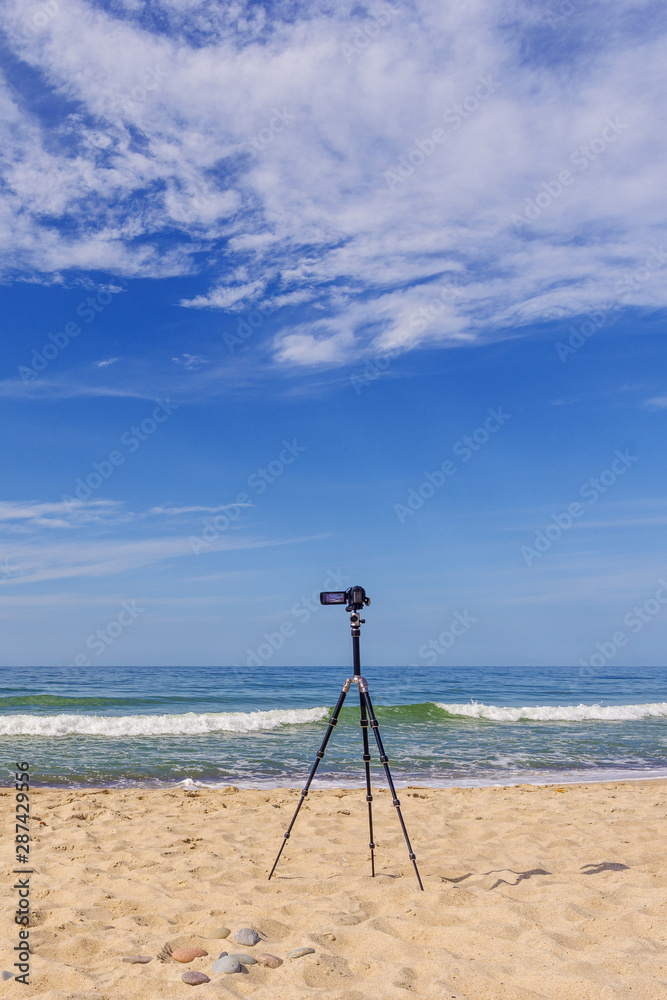 The camera stands on the beach of the summer sea. The photographer's ...