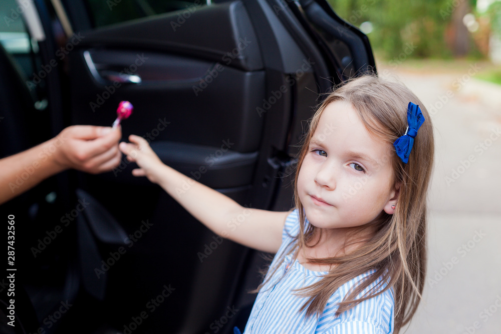 Stranger in the car offers candy to the child. Kids in danger. Children ...