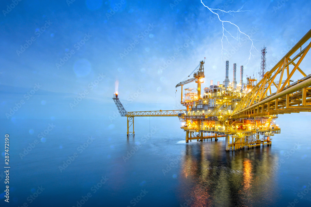 Offshore oil and gas platforms are in the process of releasing gas to ...