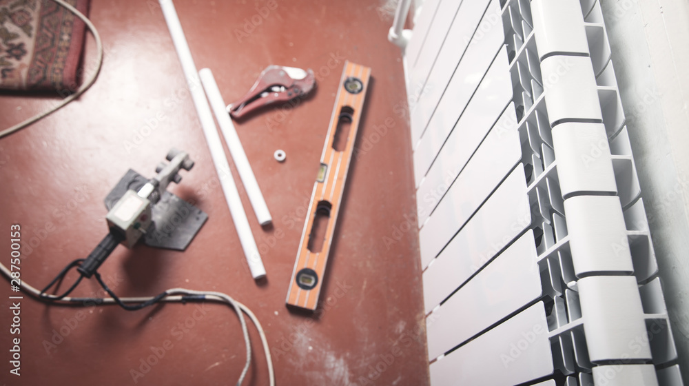 Connecting plastic pipe. Installing water heating radiator Stock Photo ...