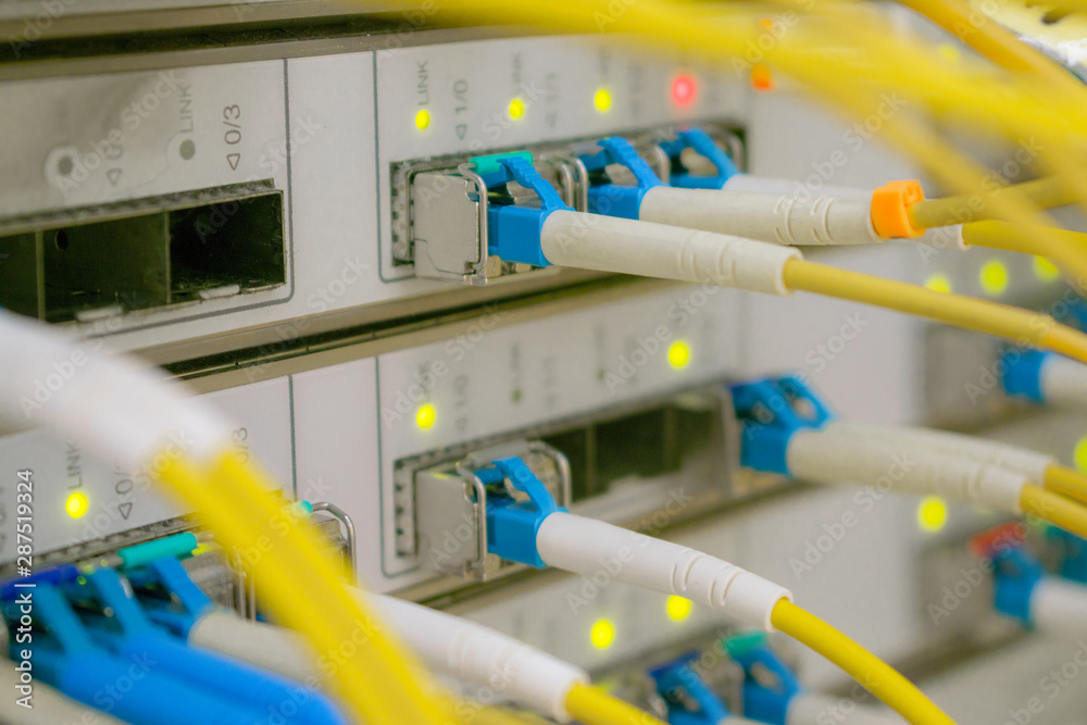 Many yellow internet cables. Front panel of the central router with a ...