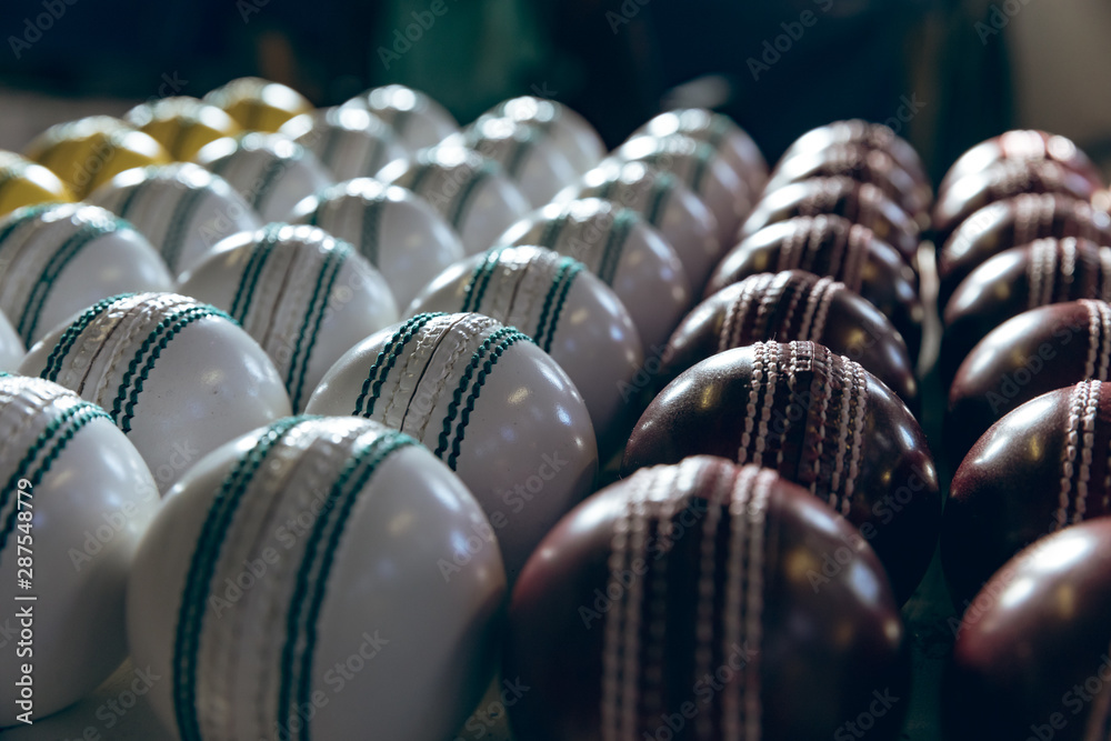 Red, white and yellow cricket balls in rows Stock Photo | Adobe Stock
