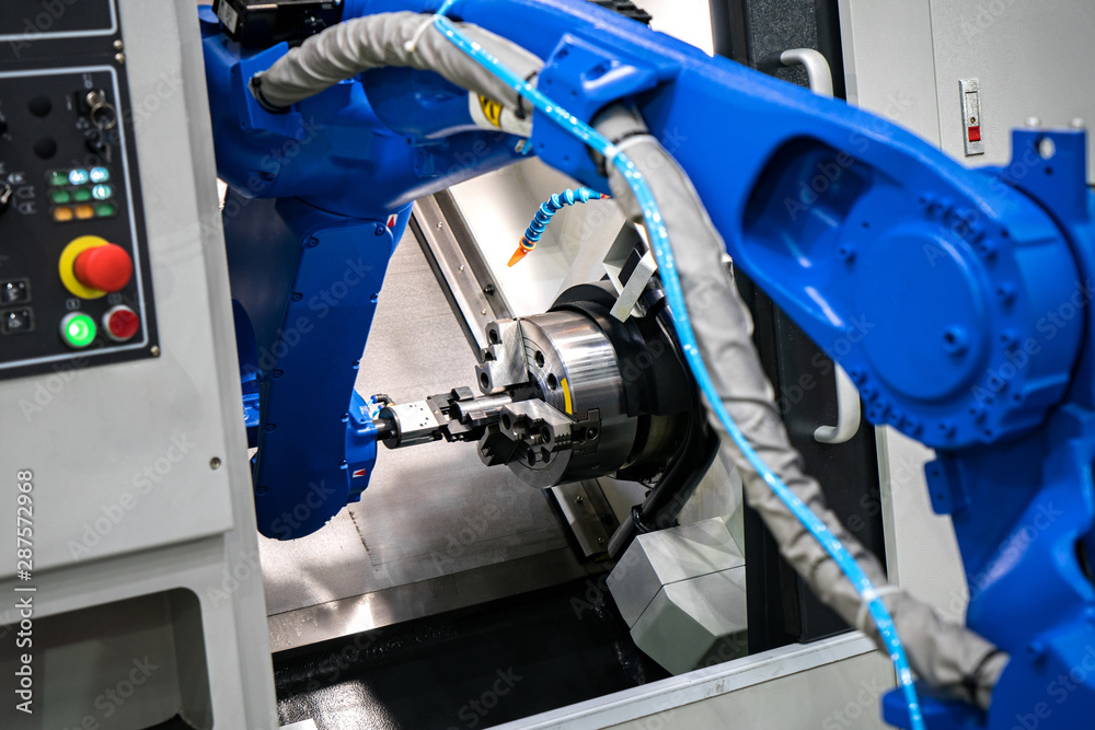 Close up robot hands in milling /drilling metalworking process ...