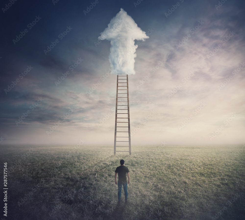 Confident man standing in front of ladder going up to the sky reaching ...