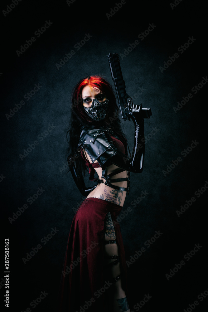 Young black-eyed Cyborg in leather armor holding a revolver in his hand ...