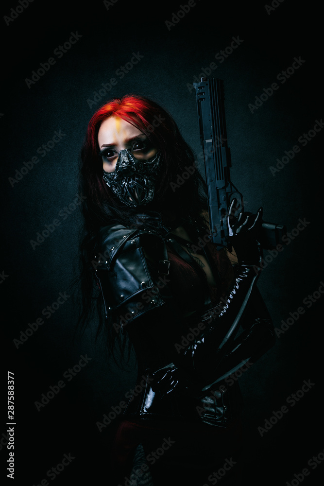 Young black-eyed Cyborg in leather armor holding a revolver in his hand ...