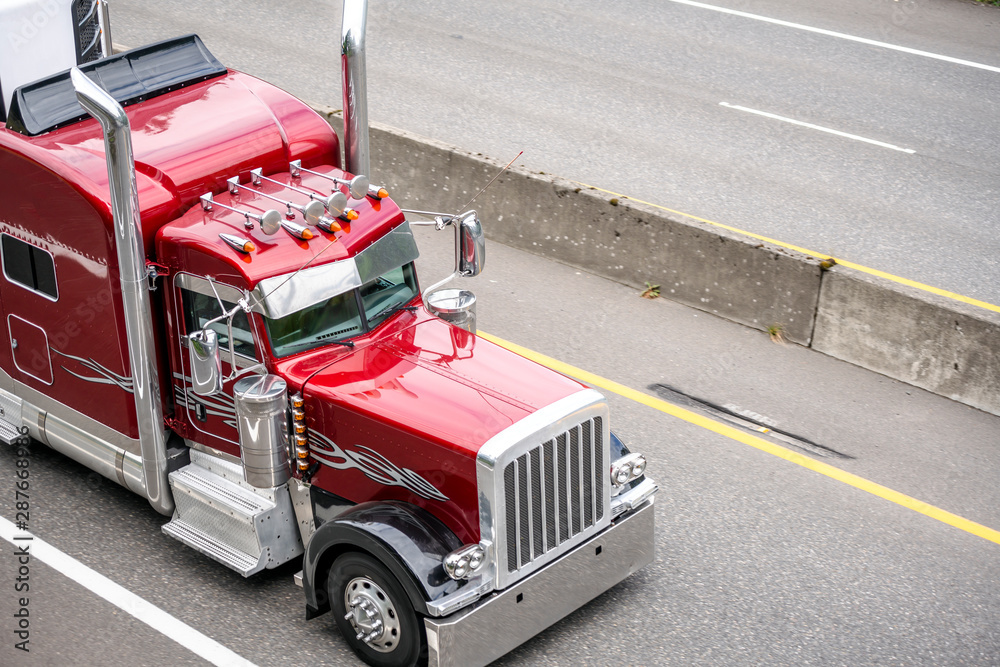 Red big rig classic semi truck tractor with chrome accessories and roof ...