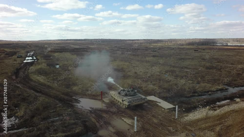 Aerial shot of tank firing at training range during military exercise ...