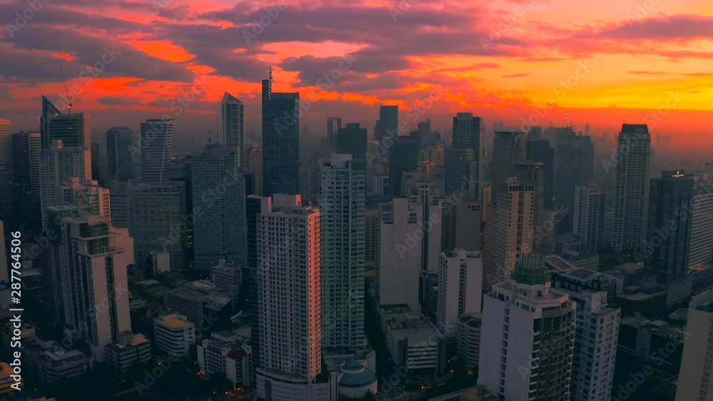 Beautiful sunrise above the high rise buildings in Manila city ...