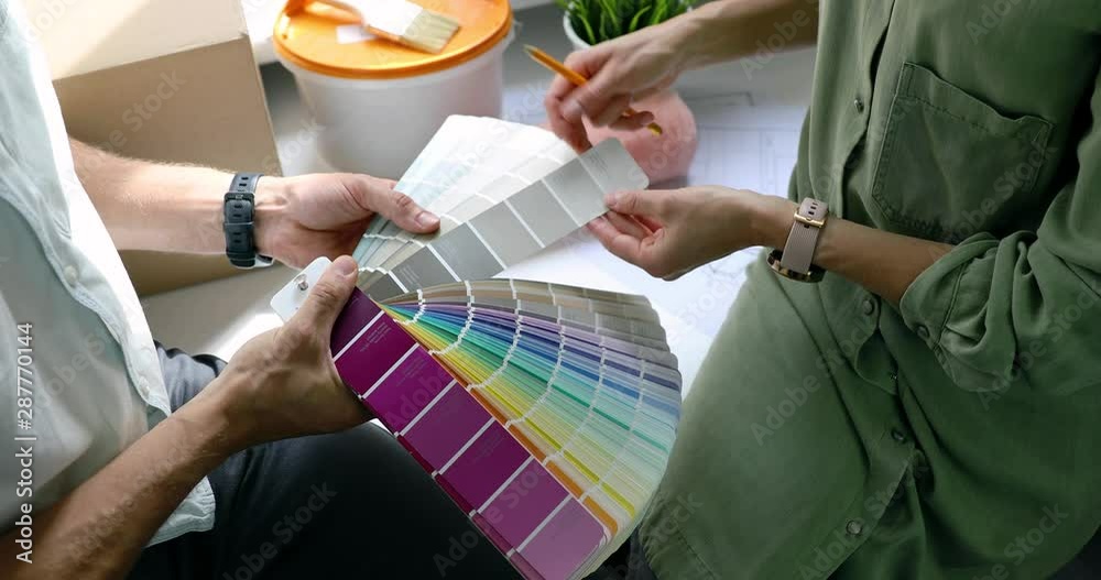 people discussing and choosing paint color from swatch for new home ...