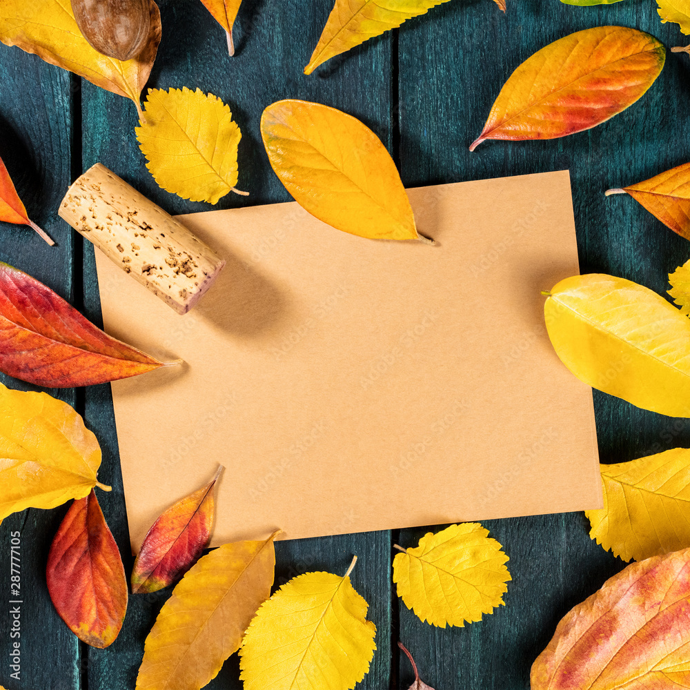 Autumn leaves and wine cork flat lay overhead shot with a card for copy ...